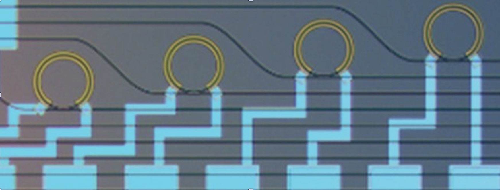 Optical microscope image of thermally tunable micro-ring resonators for 1550 nm light (waveguide loss ~0.13 dB/cm) fabricated using the silicon nitride platform.